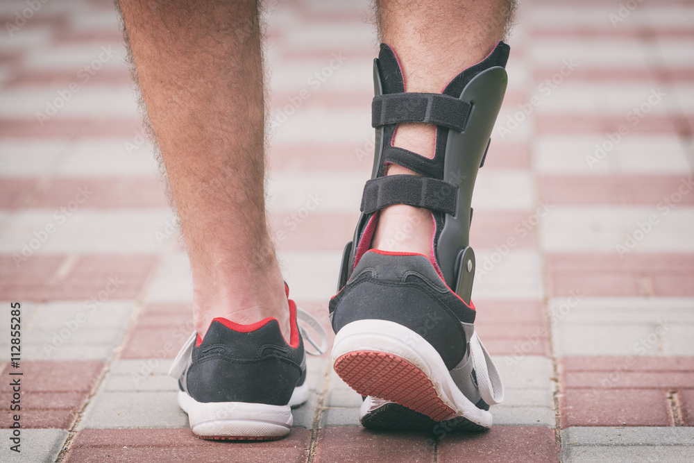 Man wearing ankle brace Stock Photo | Adobe Stock