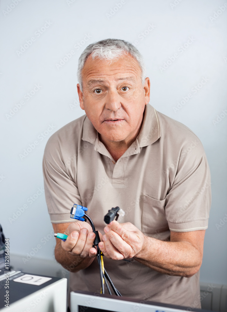 Confused Senior Man Holding Computer Cables In Class Stock Photo ...