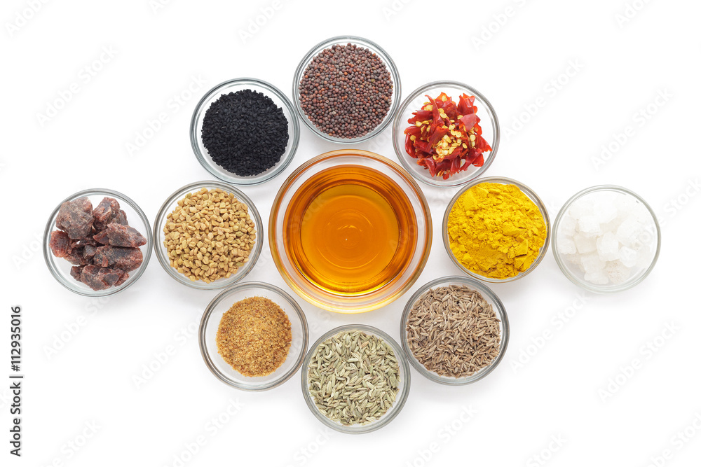 Different types of Indian spices with mustard oil in glass bowl ...