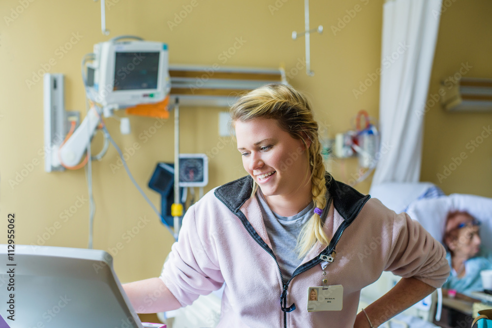 Hospital staff using computer for analysing and monitoring patient ...