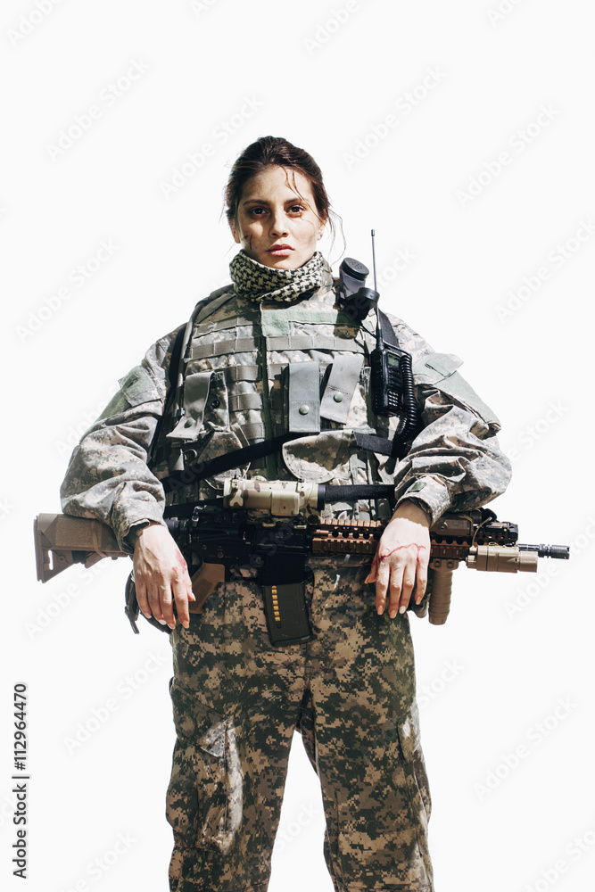 Portrait of female soldier standing with rifle against white background ...