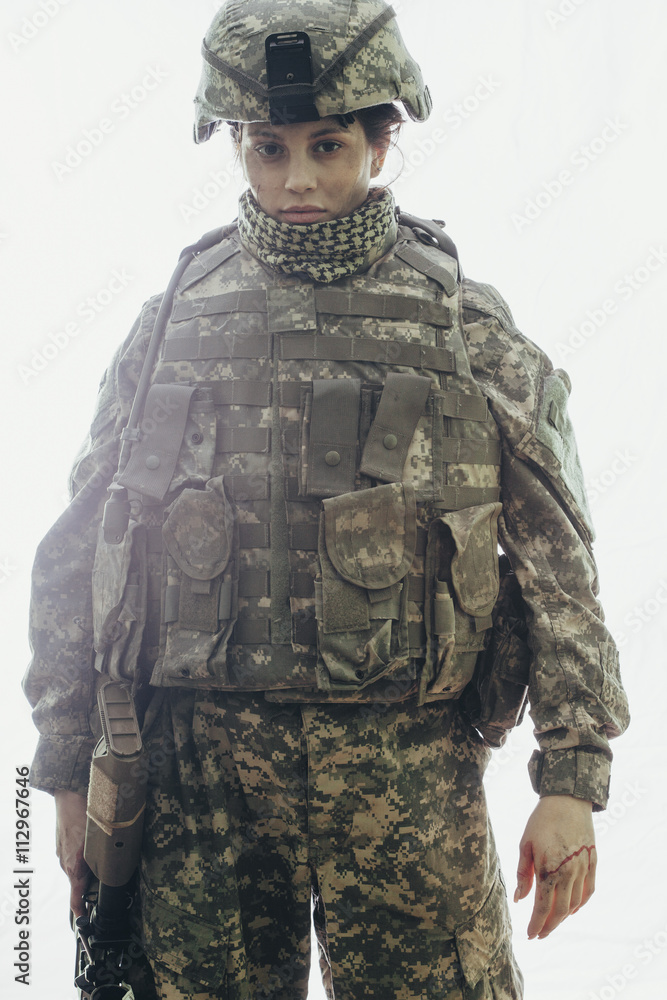 Portrait of army soldier carrying rifle standing against white ...