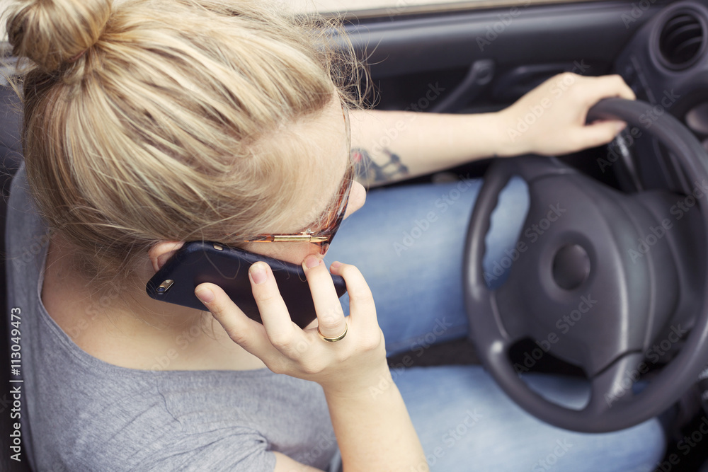 Woman making a phone call while driving Stock Photo | Adobe Stock