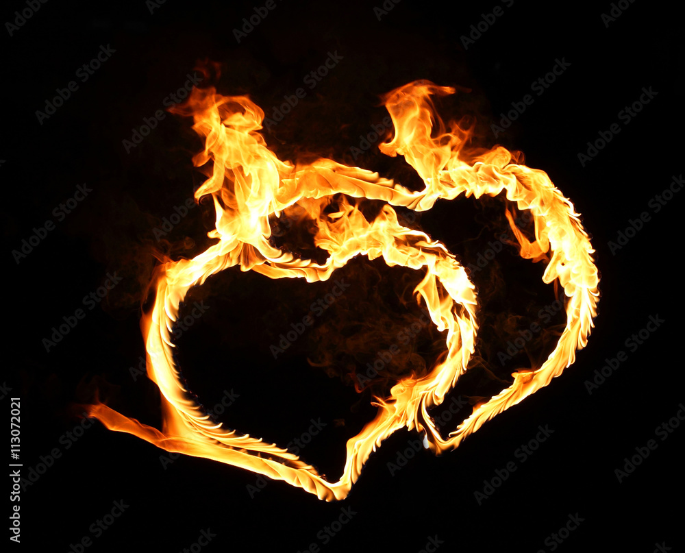 bright flamy symbol on the black background Stock Photo | Adobe Stock