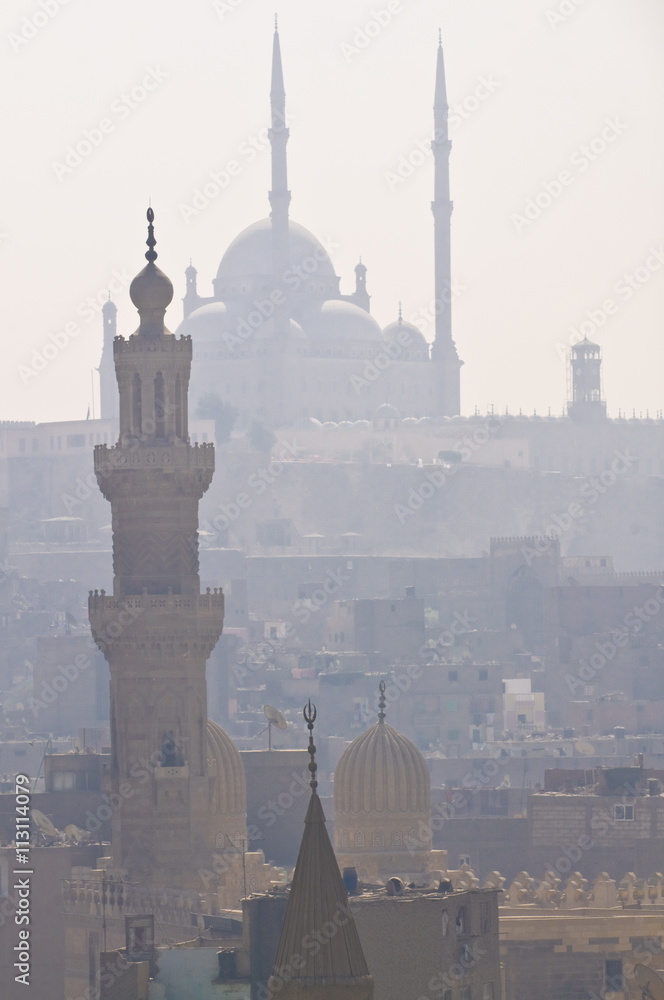 The minarets of the mosques of the old city in the smog, Cairo, Egypt ...