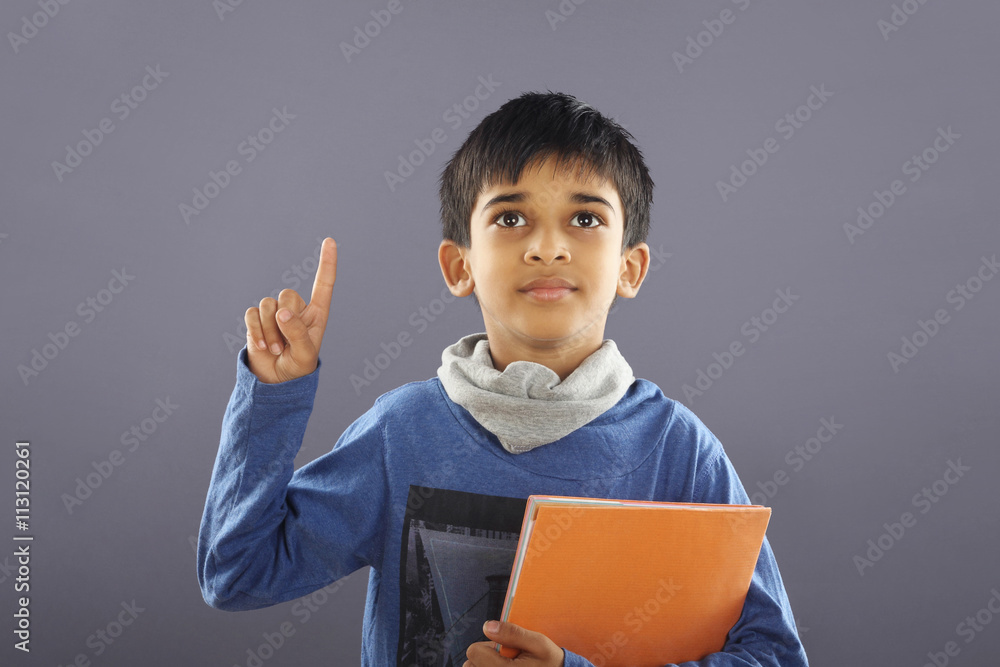 Portrait of Indian School Boy with Textbook Stock Photo | Adobe Stock