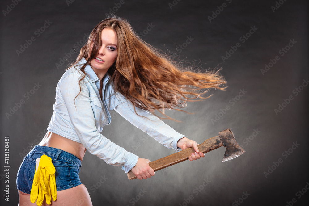 Sexy strong woman feminist with axe working. Stock Photo | Adobe Stock
