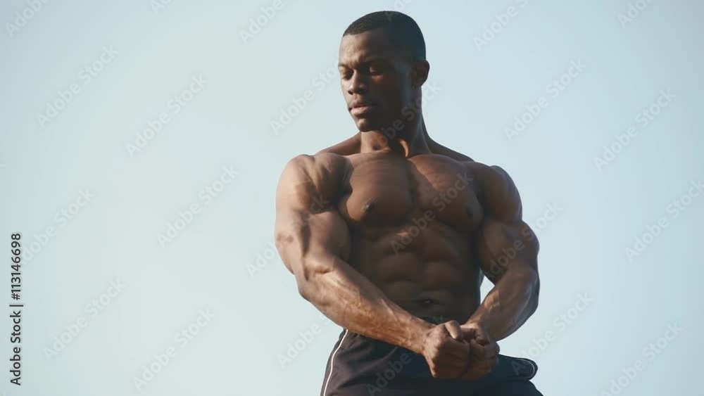 Strong handsome african american bodybuilder showing his perfect ...