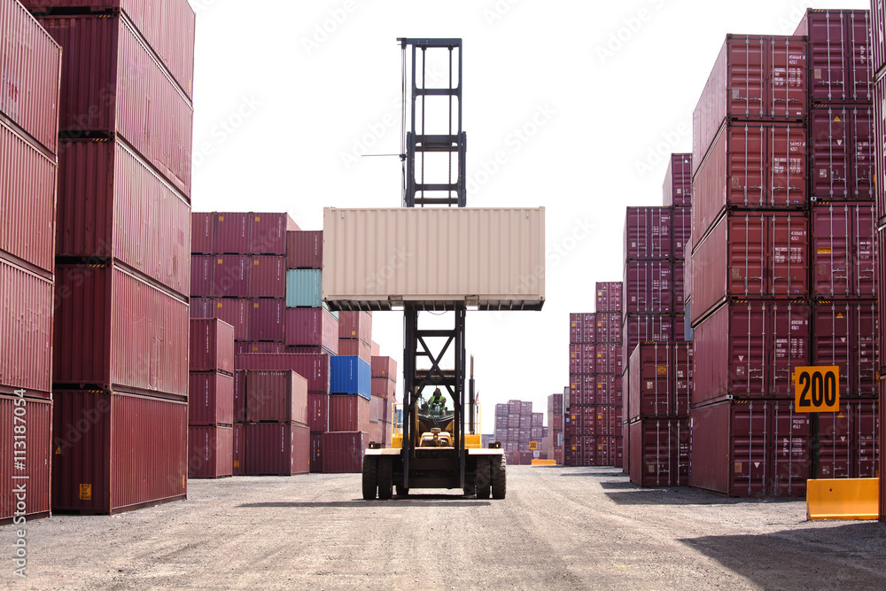 Forklift transporting cargo container in shipyard Stock Photo | Adobe Stock