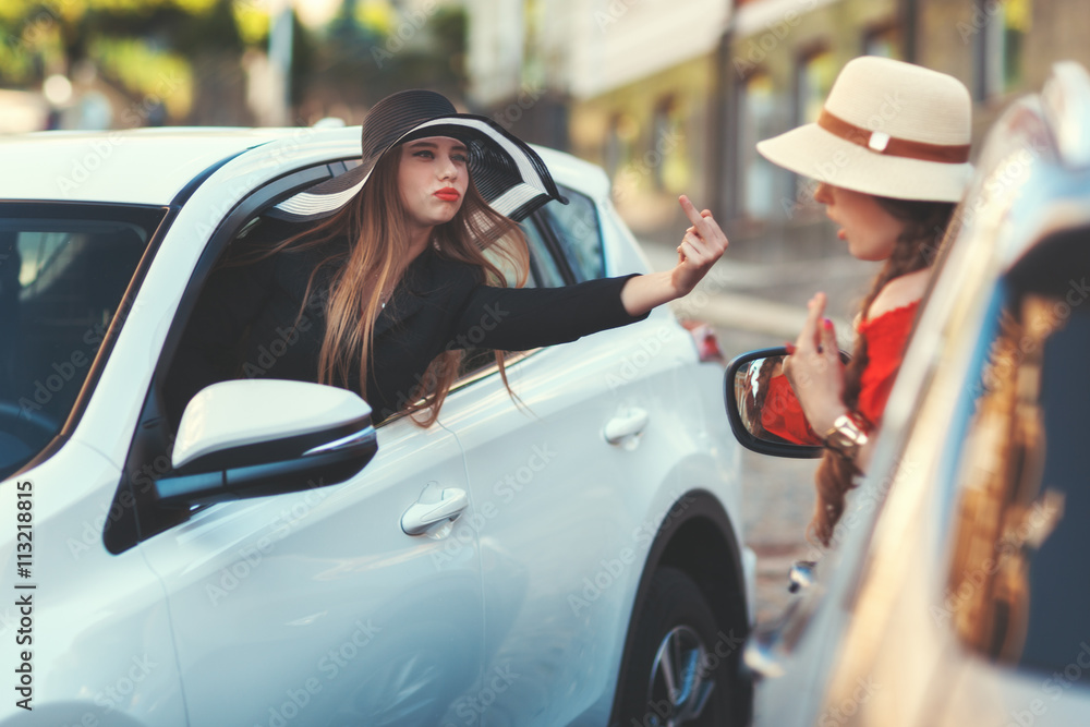 Woman from the car shows indecent gesture. Stock Photo | Adobe Stock
