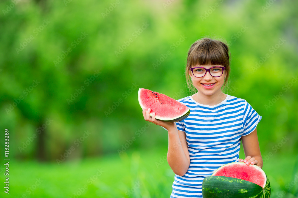 Child eating watermelon. Kids eat fruits in the garden. Pre teen girl ...