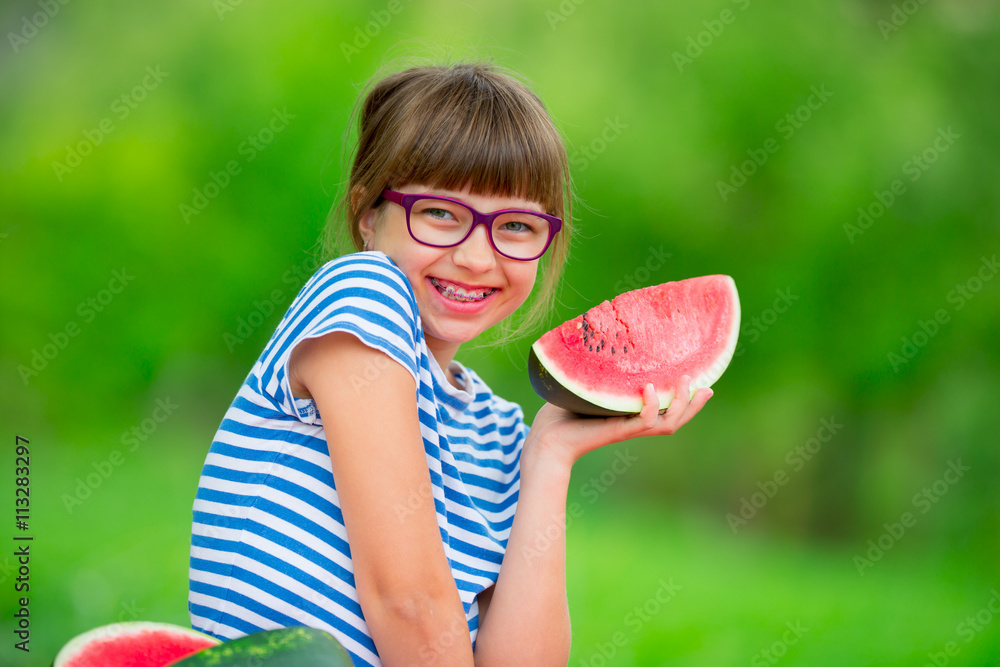 Child eating watermelon. Kids eat fruits in the garden. Pre teen girl ...