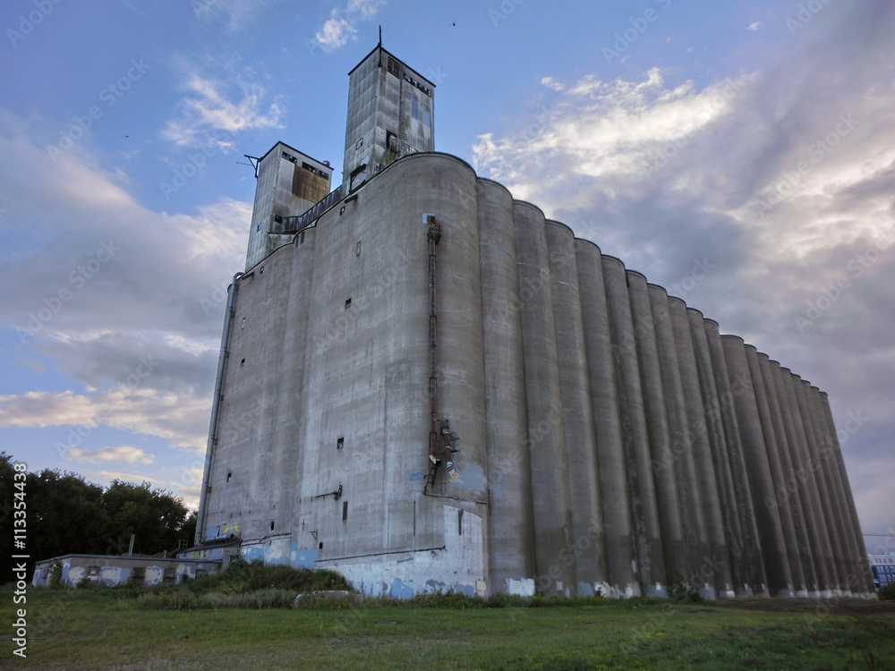 Vintage old abandoned concrete grain silos at dusk Stock Photo | Adobe ...