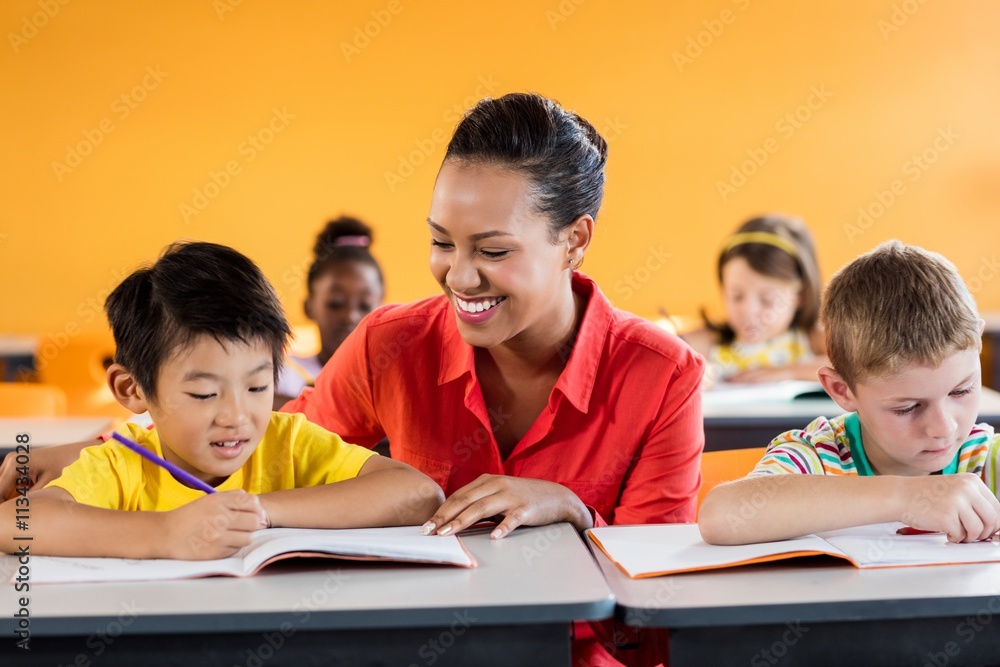 Teacher giving lesson to her students Stock Photo | Adobe Stock