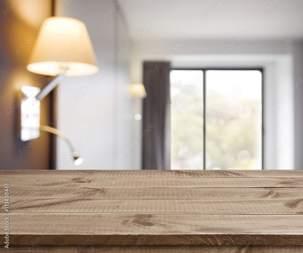 Empty wooden table on defocused simple hotel room interior background ...