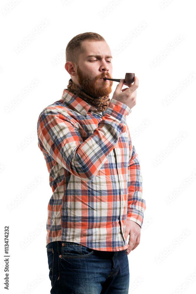 Portrait of handsome bearded man in checked shirt smoking pipe. Studio ...
