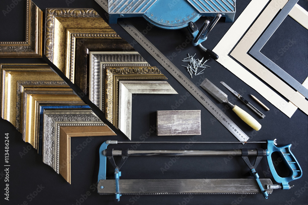 Overhead view of picture frame samples and work tools on table Stock ...