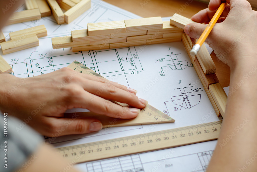 Mechanical engineer at work. Technical drawings. Paper with technical ...