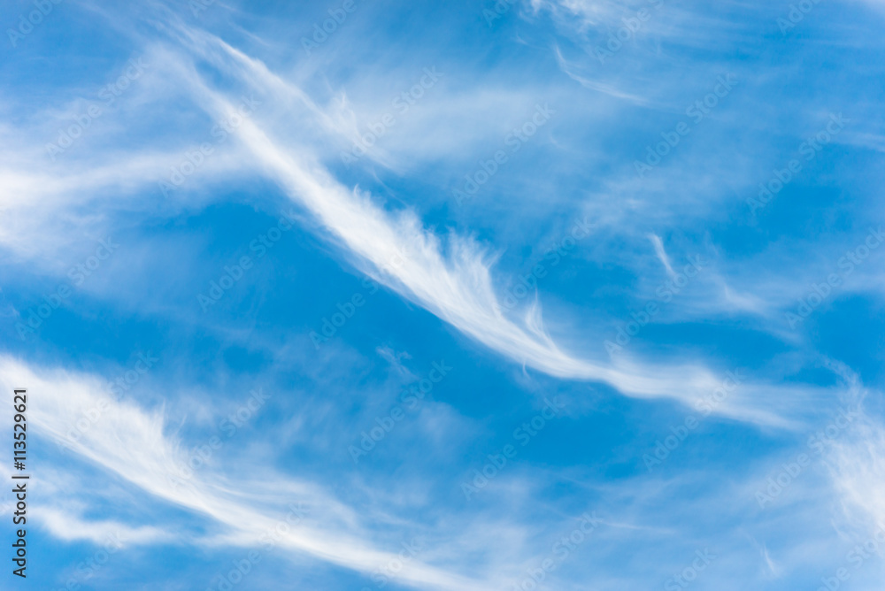 Cirrus clouds in the blue sky of Crete. The clouds looks like thin ...