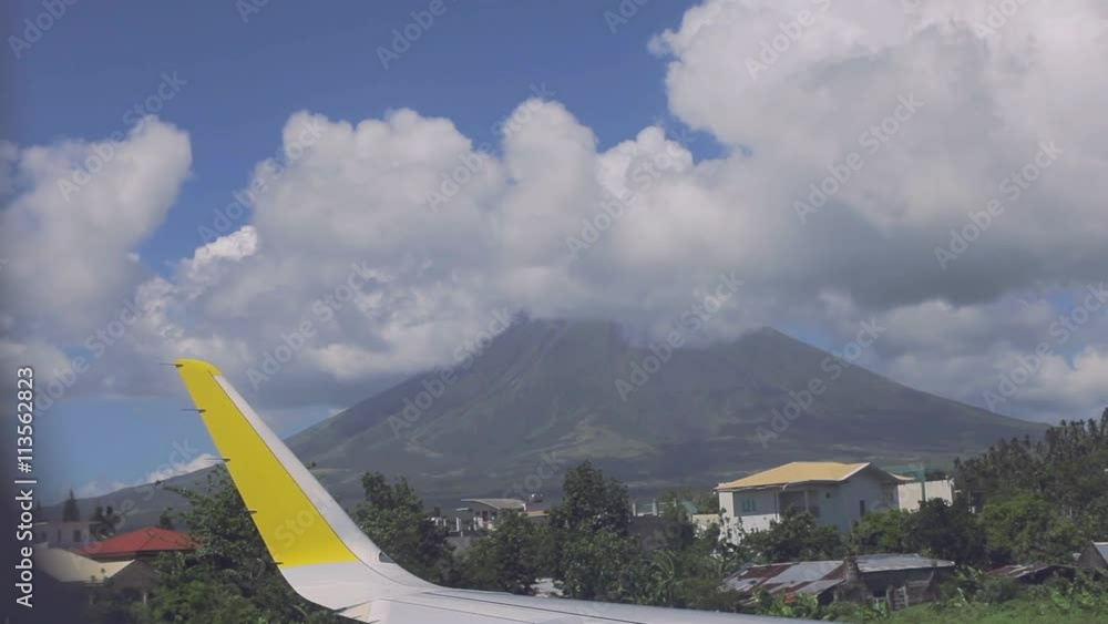 Handheld shot out of an airplane window over airport runway, rural ...