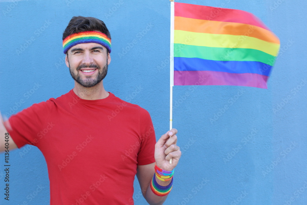 Gay male proudly holding the LGBT flag Stock Photo | Adobe Stock