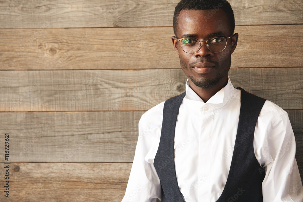 Upper body shot of intelligent African-American man in round glasses ...
