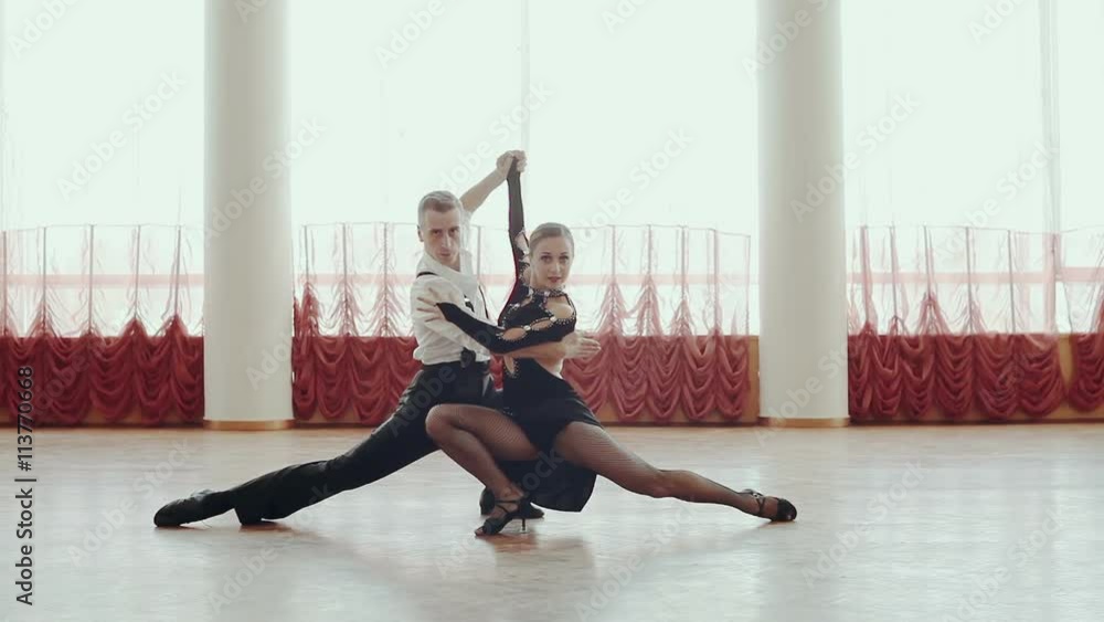 Beautiful couple of professional artists dancing passionate dance ...