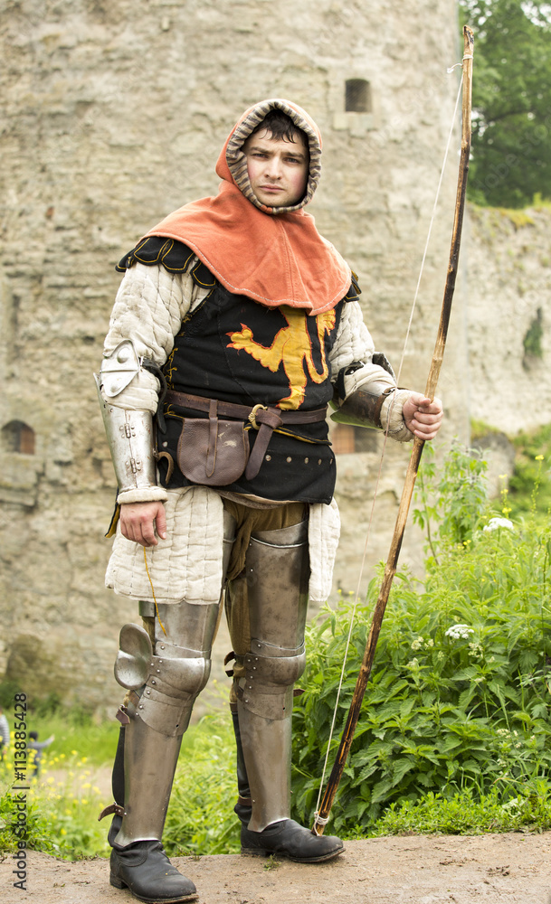 Young man in medieval knight costume wit a bow Stock Photo | Adobe Stock