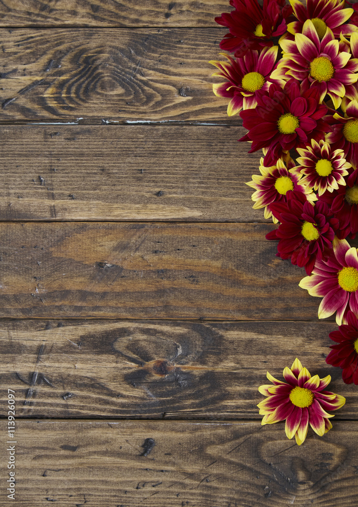 Floral border - Yellow and red flowers arranged on a rustic, distressed ...