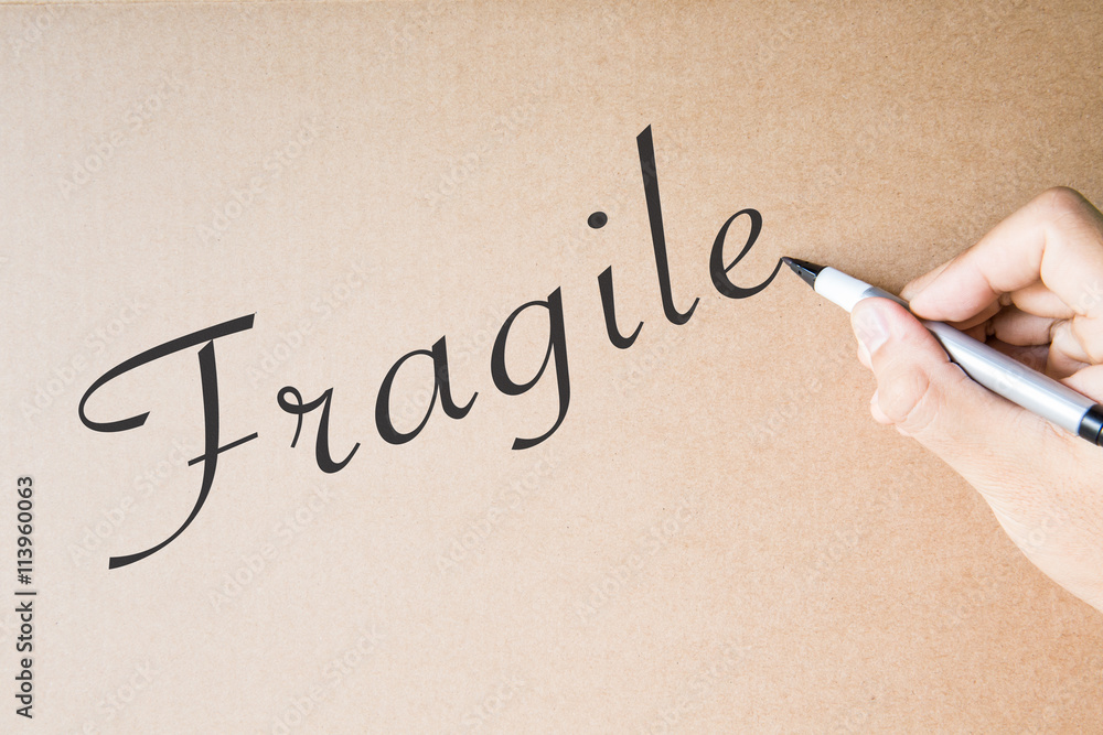 hand writing fragile on brown paper background Stock Photo | Adobe Stock