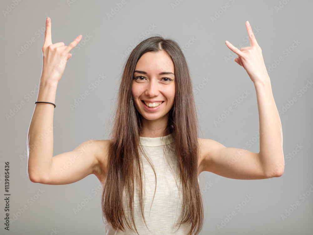 Young girl showing horns Stock Photo | Adobe Stock