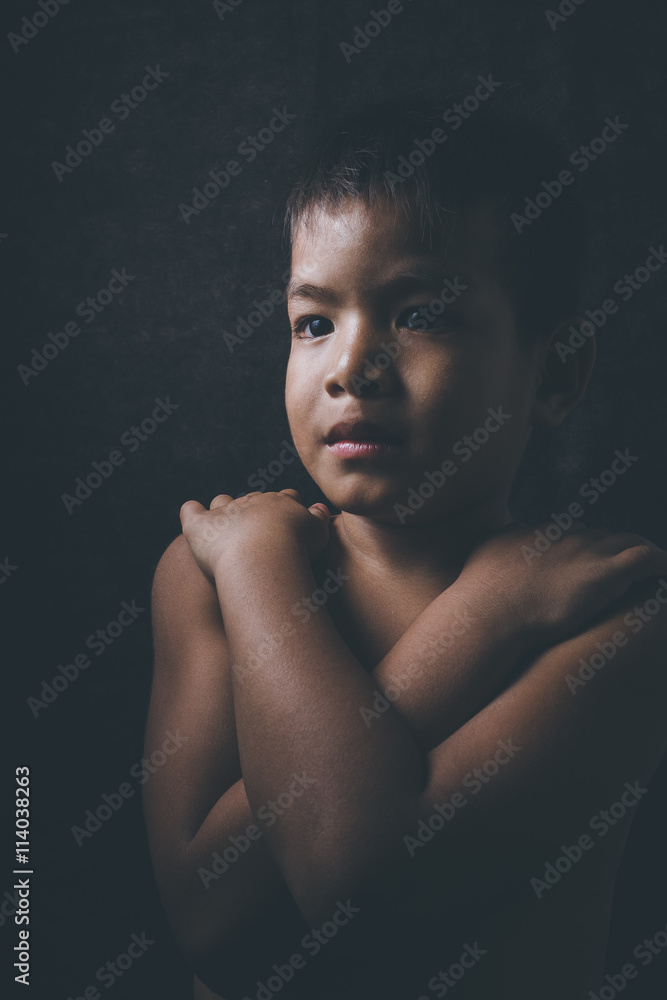 scared and alone, young Asian child who is at high risk of being ...