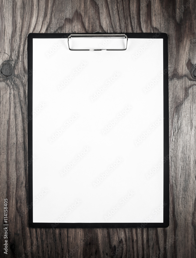 Blank letterhead. Blank sheet of paper in clipboard on dark wooden ...