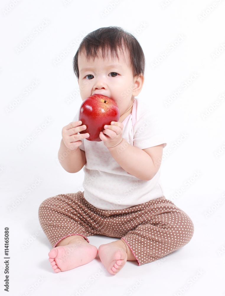 Cute baby with red apple (eating healthy food) on white background ...