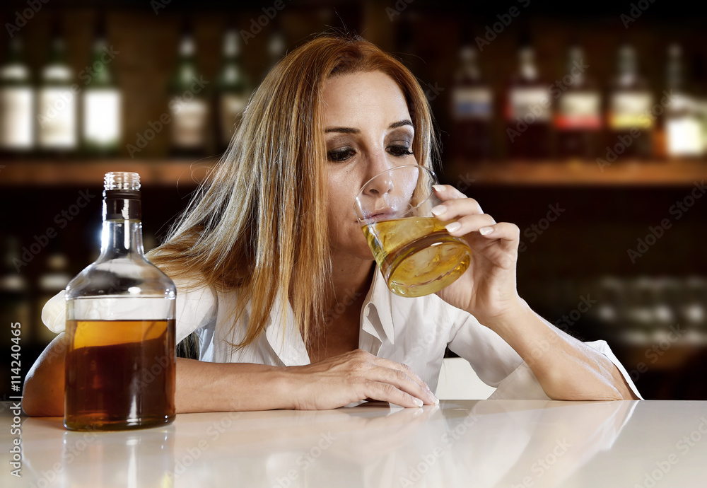 drunk alcoholic woman wasted drinking on scotch whiskey in bar Stock ...