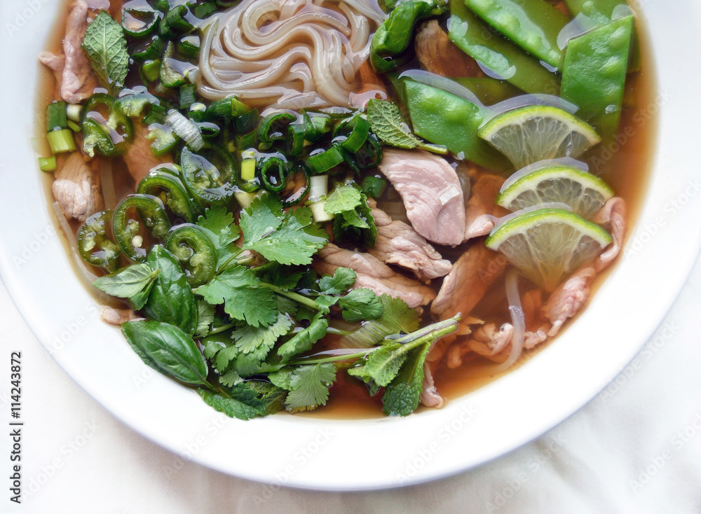 High angle shot of asian inspired beef soup with fresh vegetables ...