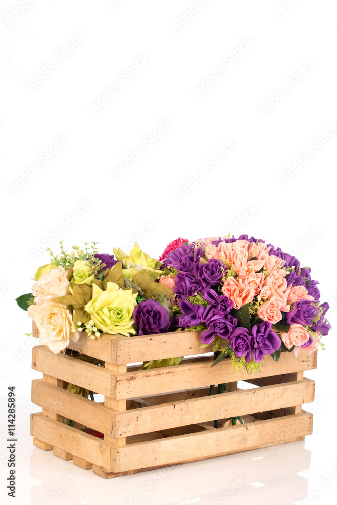 Wooden box with plastic flowers on white background ,selective focus ...
