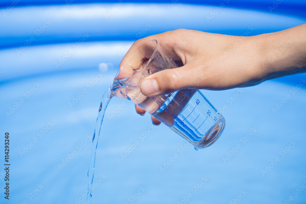 Water testing at swimming pool, laboratory glassware in hand Stock ...