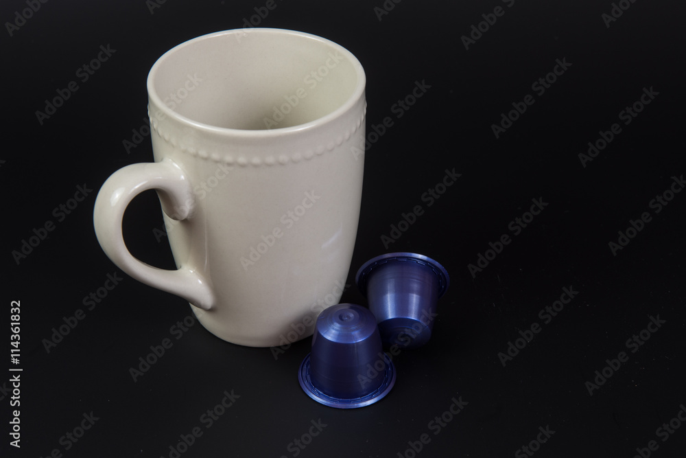 Coffee mug with capsules Stock Photo | Adobe Stock