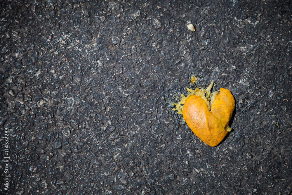Smashed orange shaped like broken heart on the asphalt Stock Photo ...