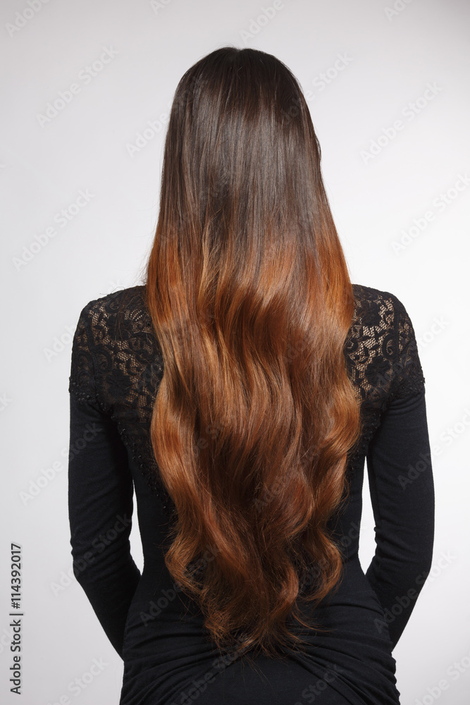 Back view of beautiful woman demonstrating her gorgeous brown hair ...