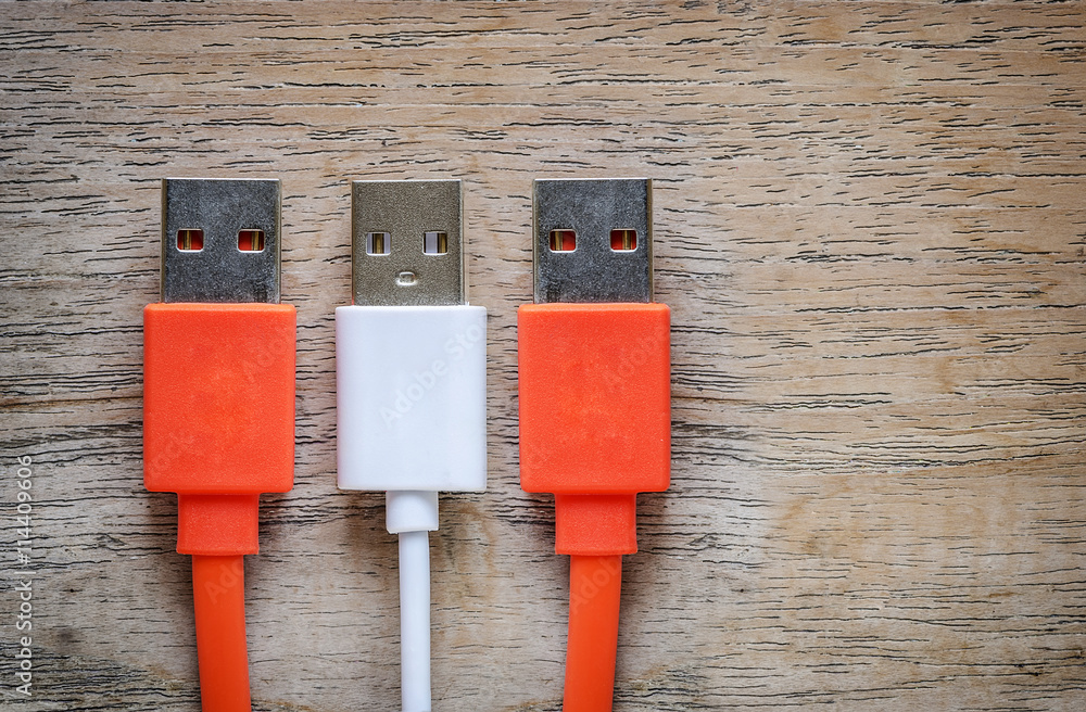 Orange and white USB cable Plug on wooden background. Stock Photo ...
