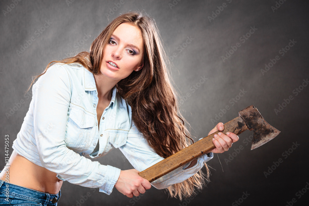 Sexy strong woman feminist with axe working. Stock Photo | Adobe Stock