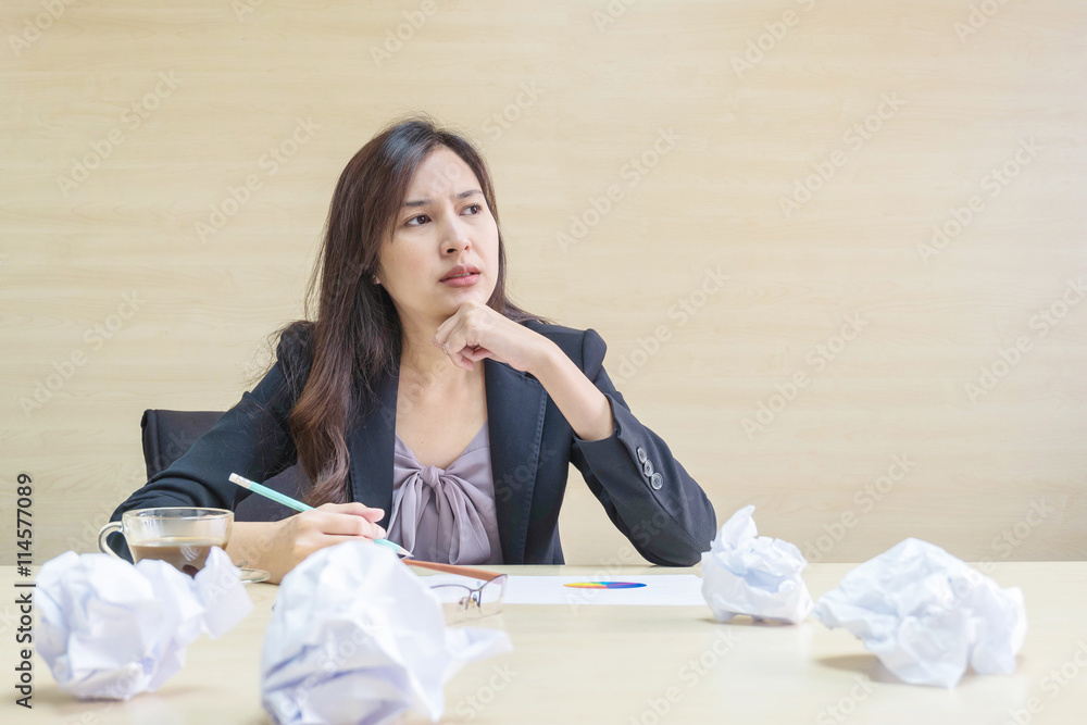 Closeup asian working woman working with thinking face and a pencil her ...