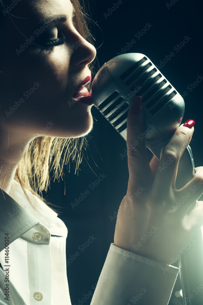 sexy woman with microphone Stock Photo | Adobe Stock