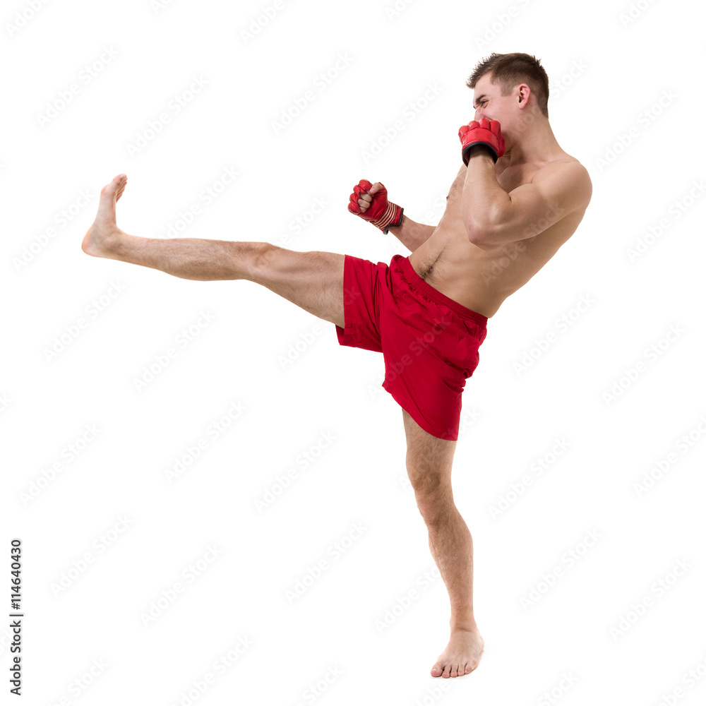 Full length portrait of young male boxer showing some movements against ...