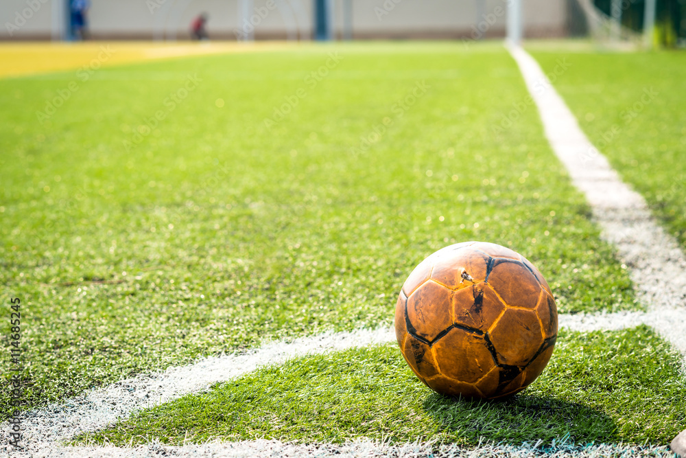 old football ball on coner in football field Stock Photo | Adobe Stock