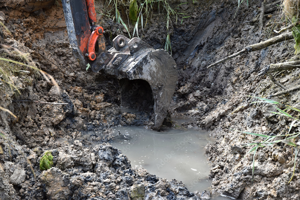 Spoon dredger wants to scoop mud from the pond Stock Photo | Adobe Stock