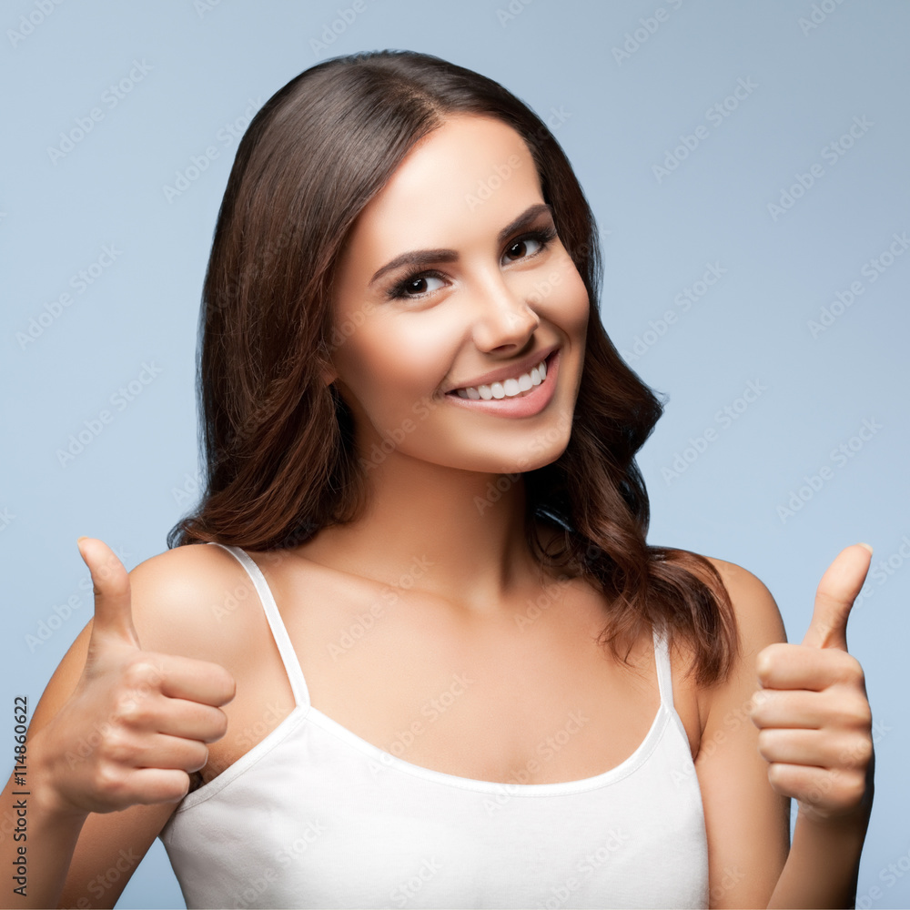 Woman showing thumbs up gesture Stock Photo | Adobe Stock
