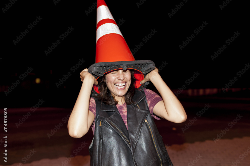 Playful young woman with a traffic cone on her head Stock Photo | Adobe ...